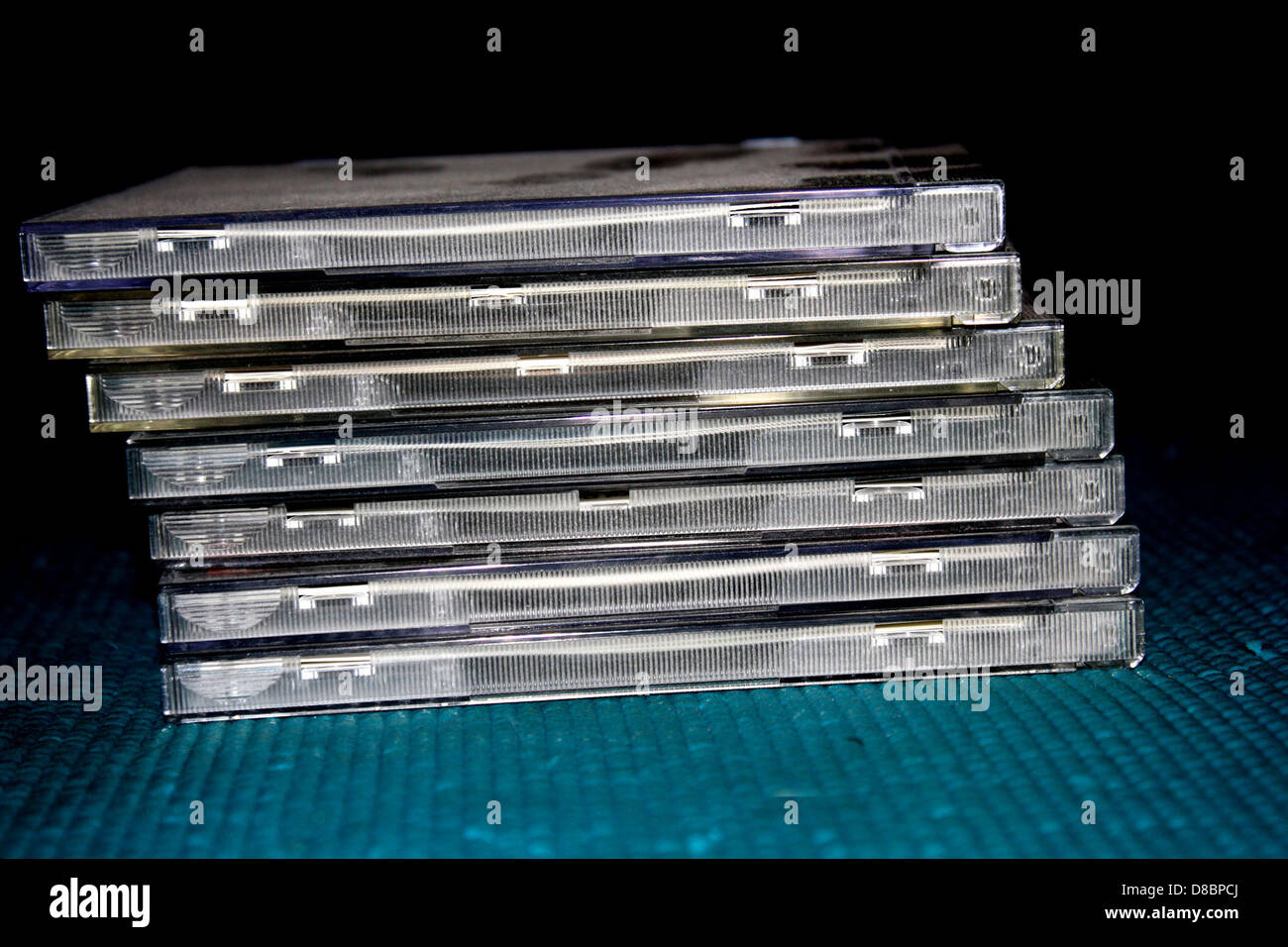 A stack of compact discs (CDs) arranged in a vertical pile. The discs ...