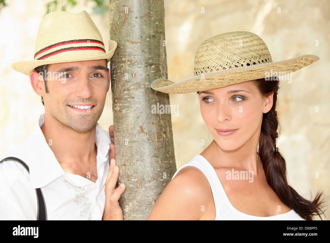 Couple wearing straw hats Stock Photo - Alamy
