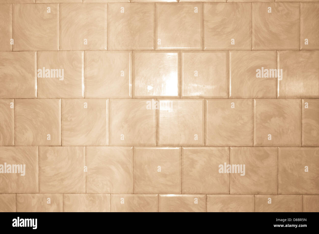 This image features a close-up view of tan bathroom tiles with a swirl ...