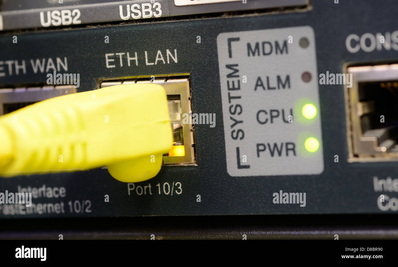 Yellow patch cord plugged to the ethernet port Stock Photo - Alamy