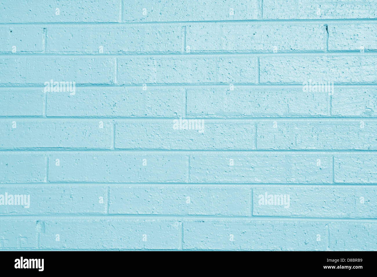 A close-up of a textured teal blue painted brick wall. The color and ...