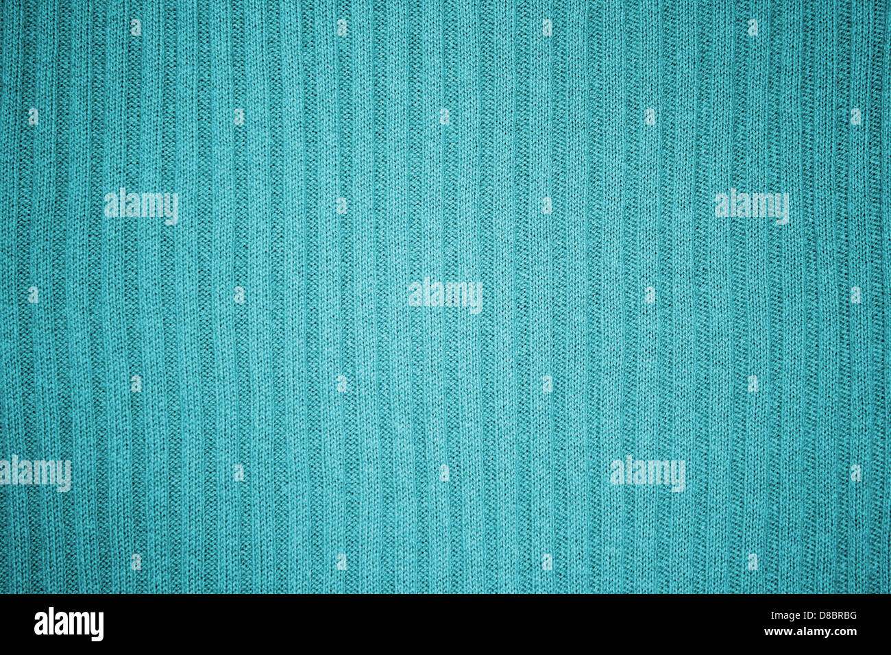 A close-up of teal blue ribbed knit fabric, showcasing the texture of ...
