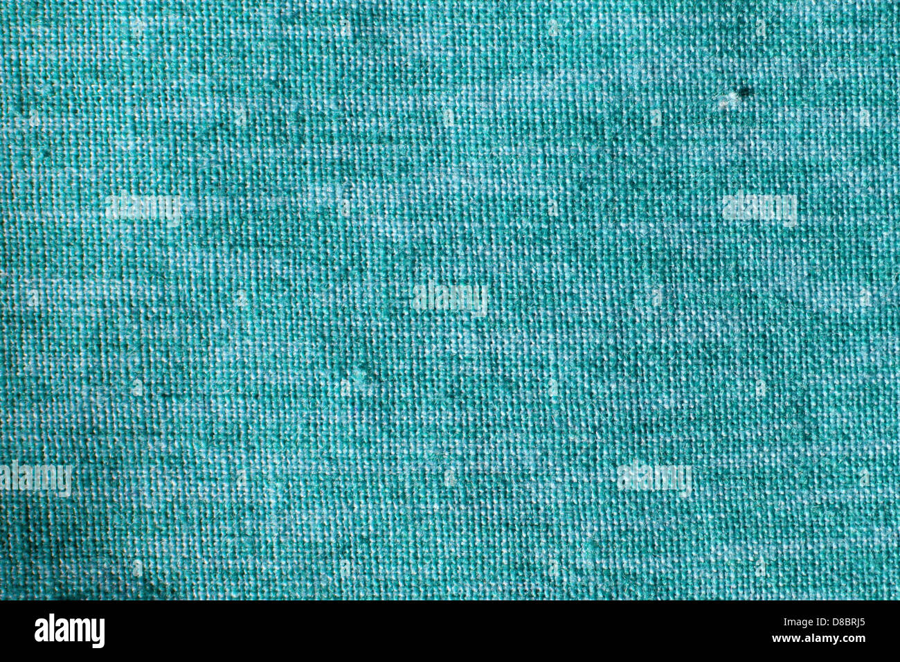 This image shows a close-up of teal woven fabric, showcasing its ...