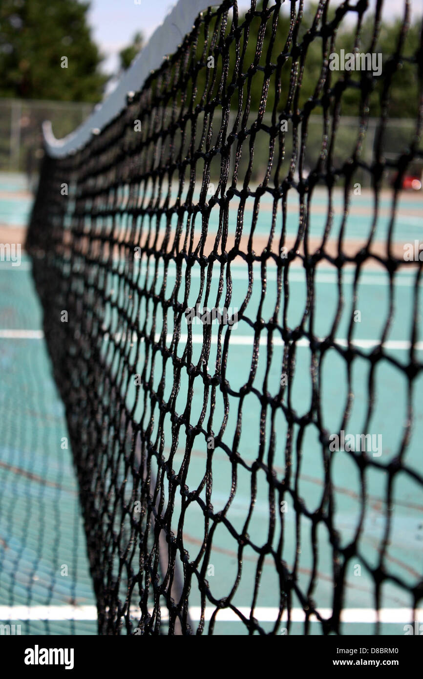 A close-up shot of a tennis court net, taut and ready for play. The net ...
