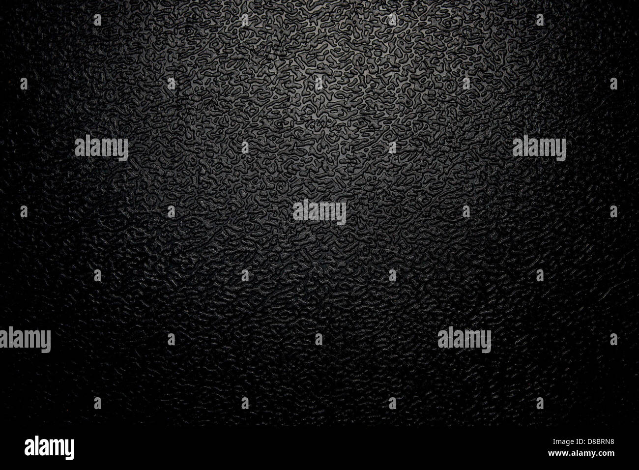 This close-up shot reveals the texture of black plastic, highlighting ...