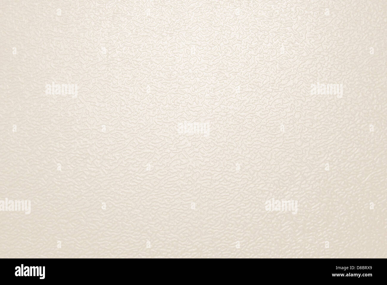 A close-up of textured cream-colored plastic, showcasing its smooth ...