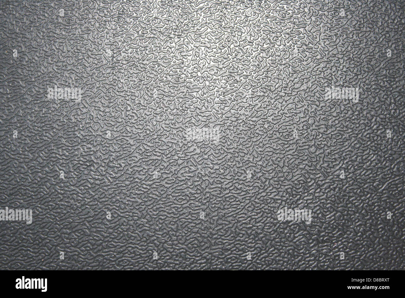 This image shows a close-up view of textured gray plastic, highlighting ...