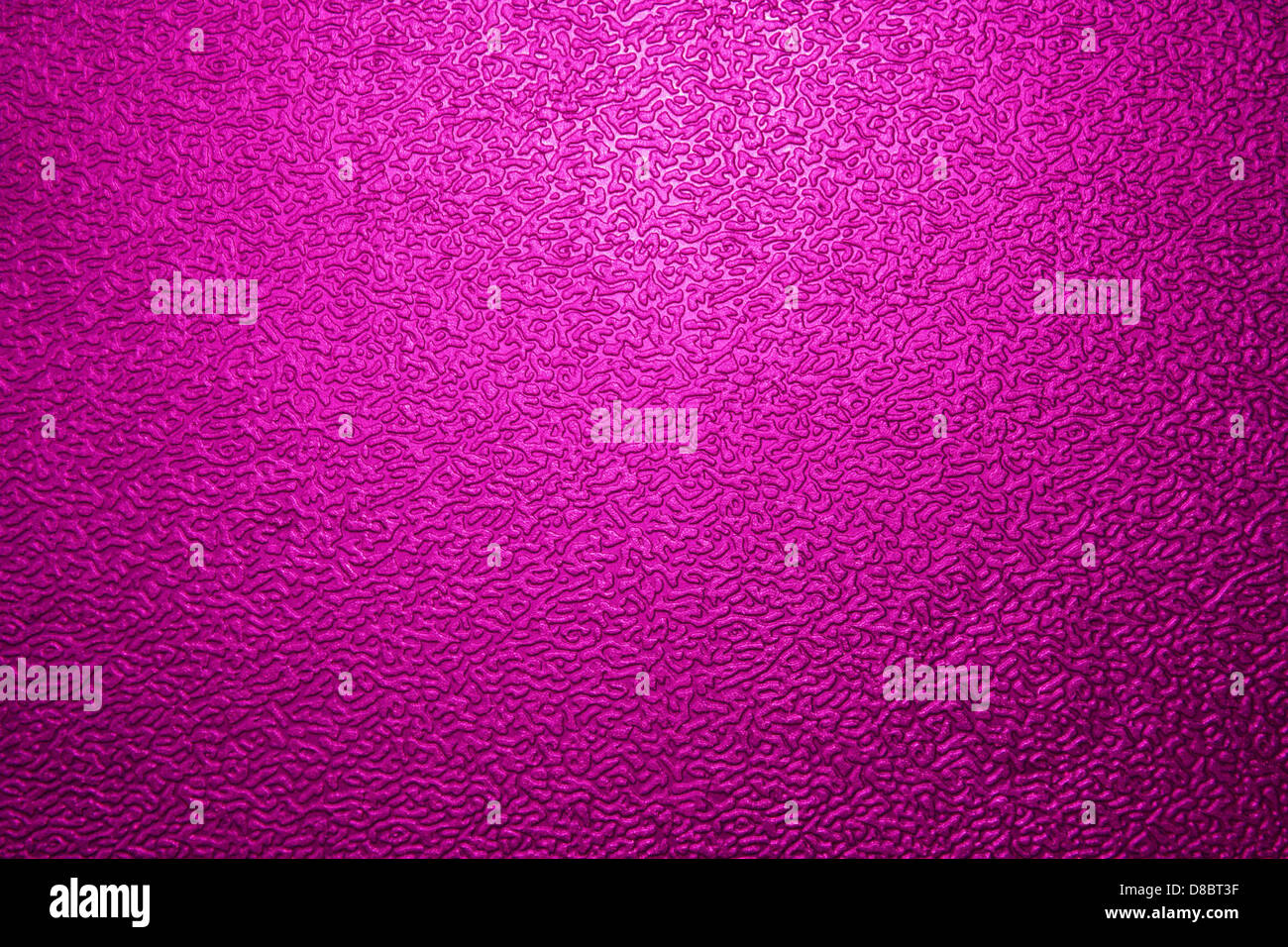A close-up image of textured hot pink plastic, showing its smooth ...