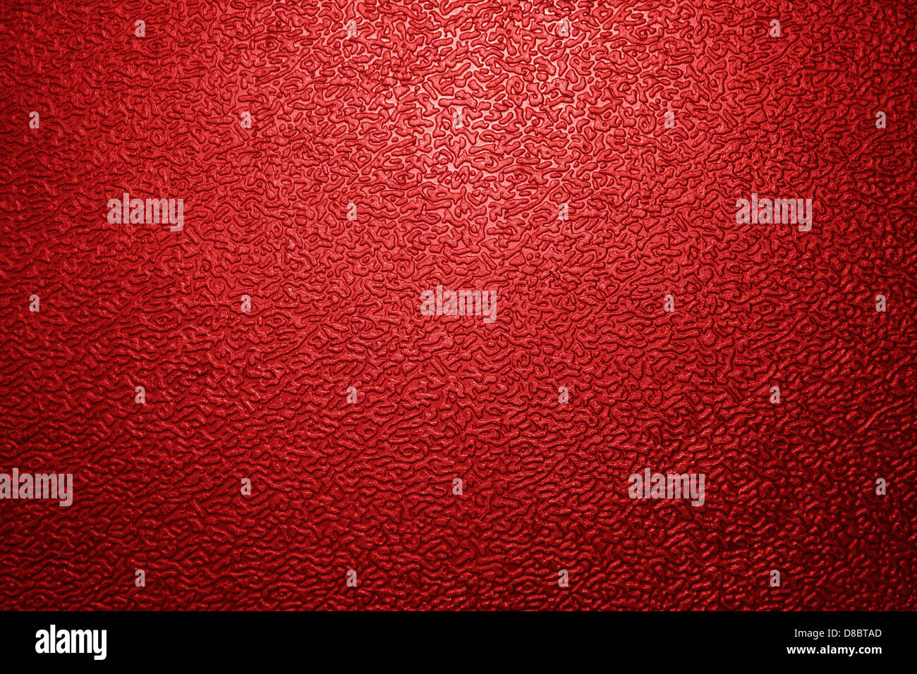 A close-up view of textured red plastic, showcasing the pattern and ...