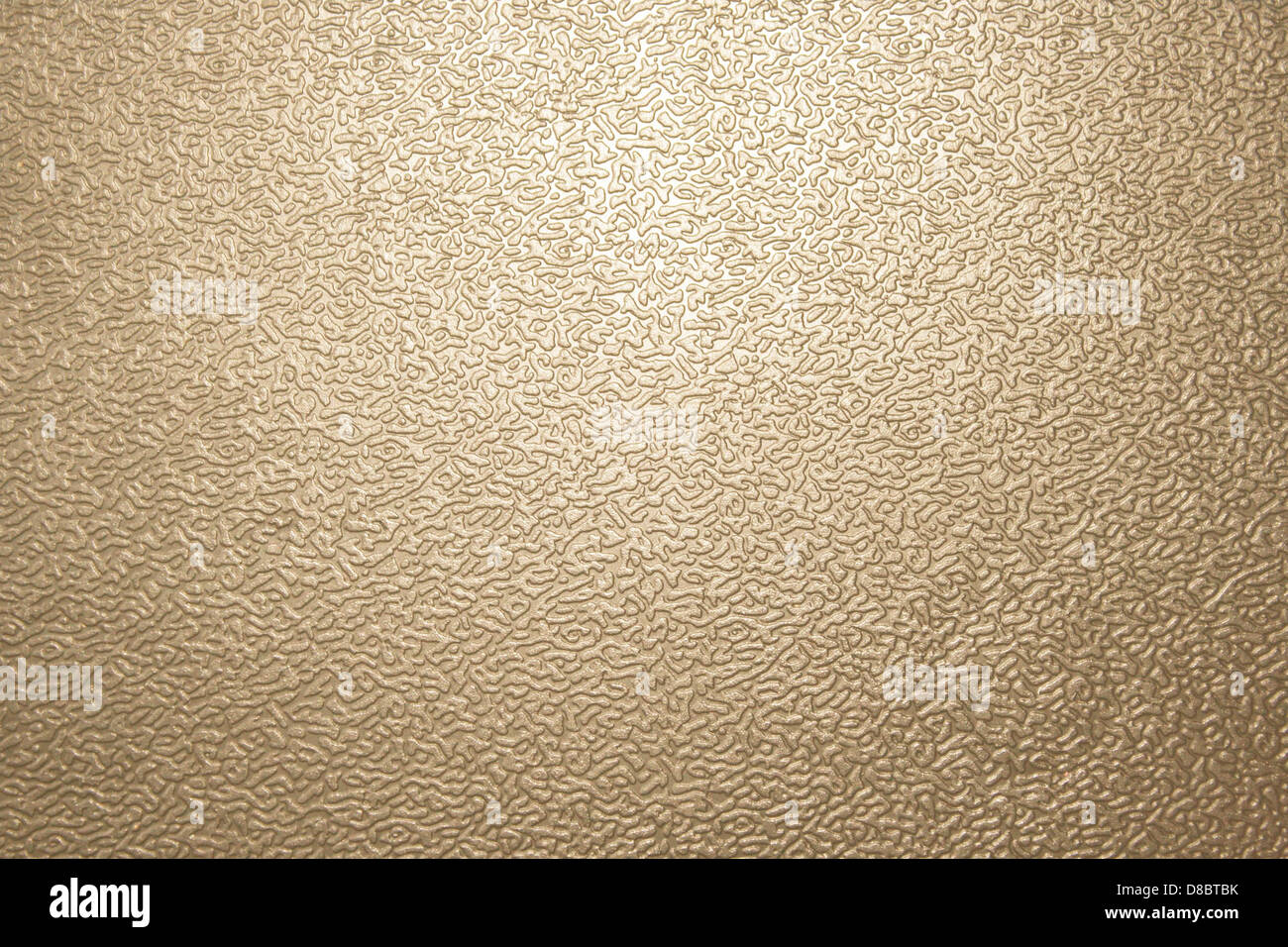 A close-up view of textured tan plastic, displaying its surface ...