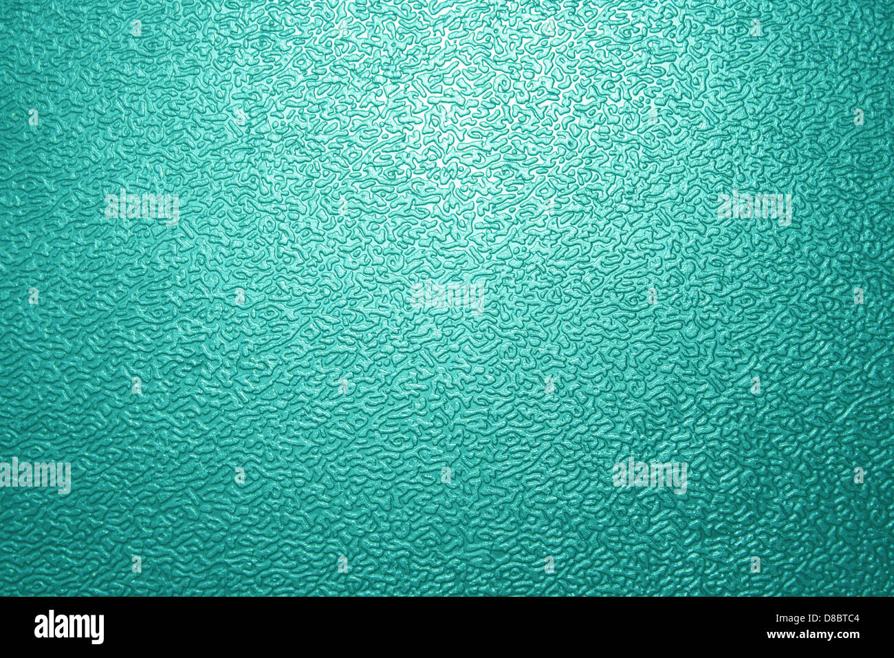 This stock photo shows a close-up of textured teal plastic, focusing on ...
