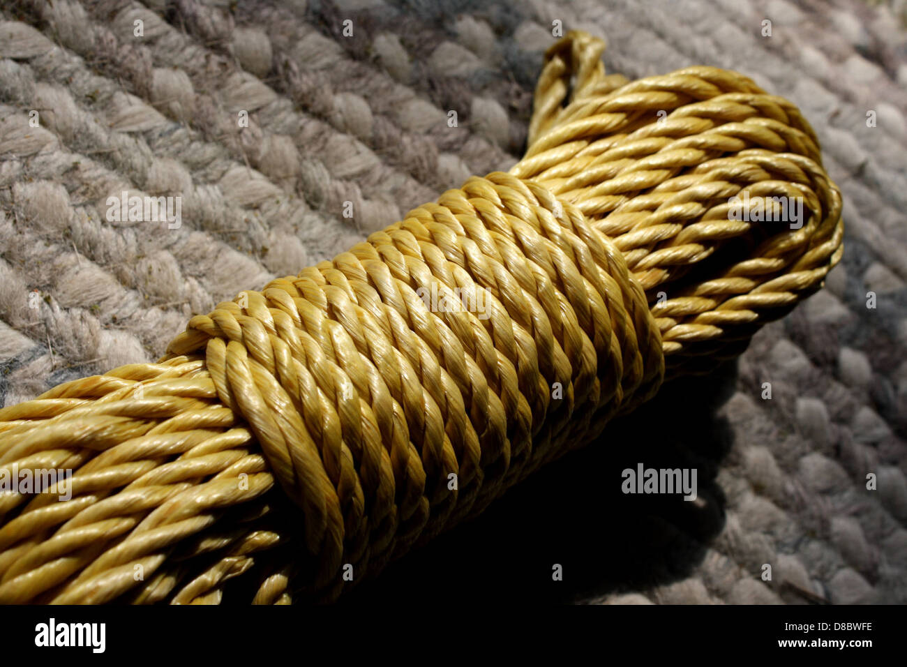 A yellow twisted rope is shown, highlighting its structure and utility ...