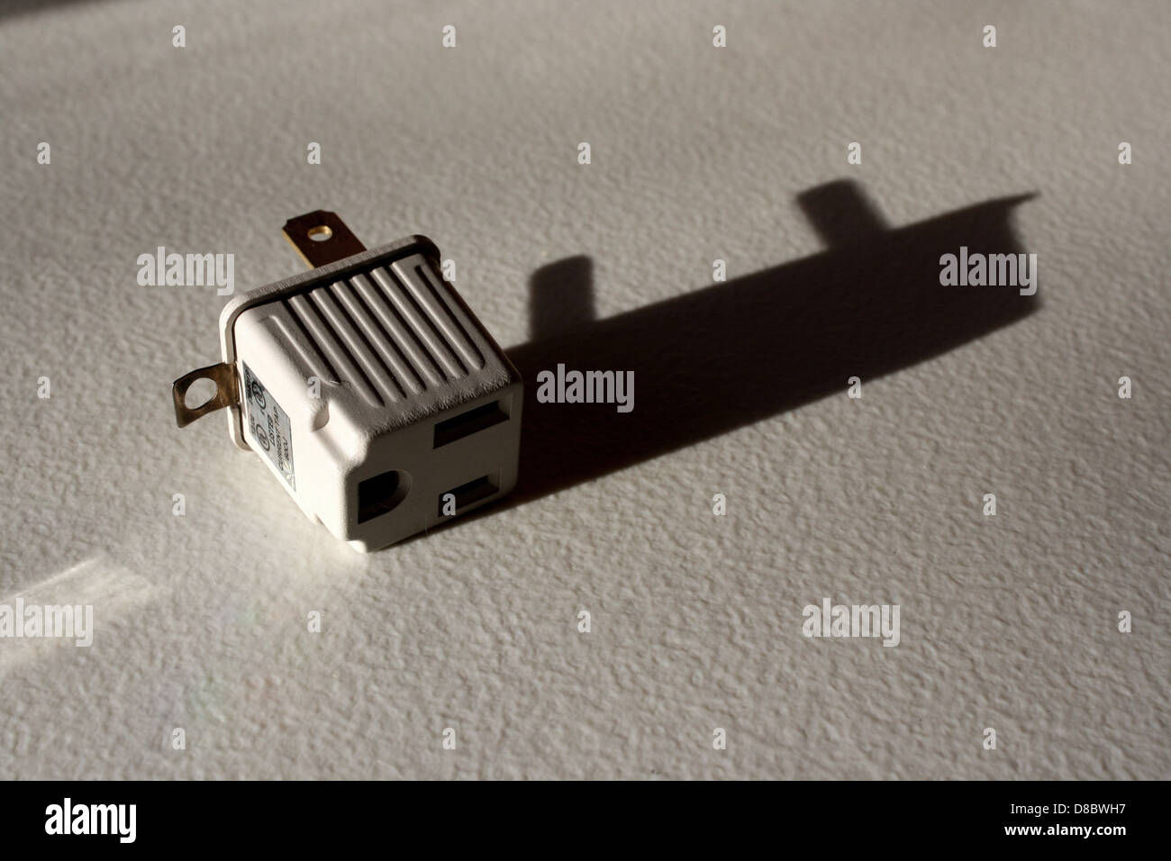 A three-prong converter plug, typically used for adapting power outlets ...