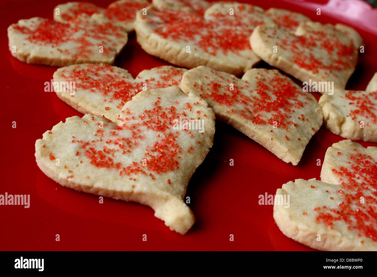 A set of heart-shaped cookies decorated with colorful icing ...