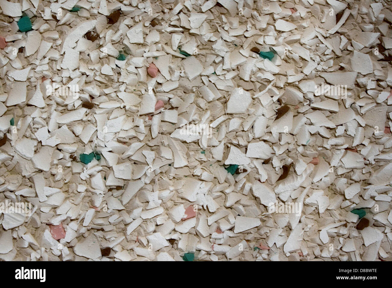 This close-up image shows the textured surface of a vinyl floor tile ...
