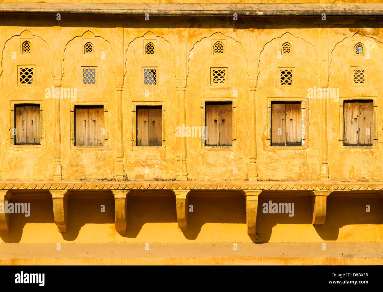 Windows with shutters in the wall of ancient Fort Amber near Jaipur ...