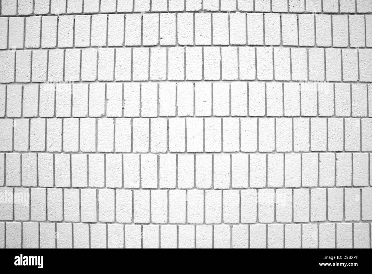 A close-up shot of a white brick wall with vertical brick alignment ...