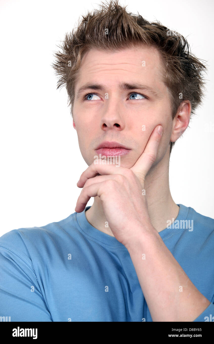 Teenage boy thinking hard Stock Photo - Alamy