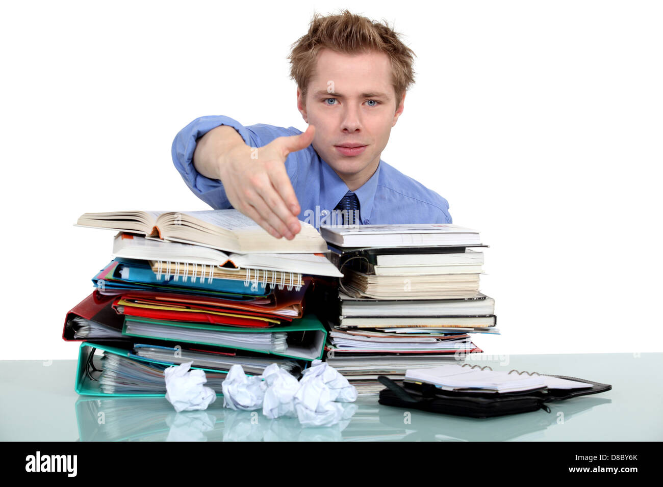 man giving his hand over a pile of folders Stock Photo - Alamy