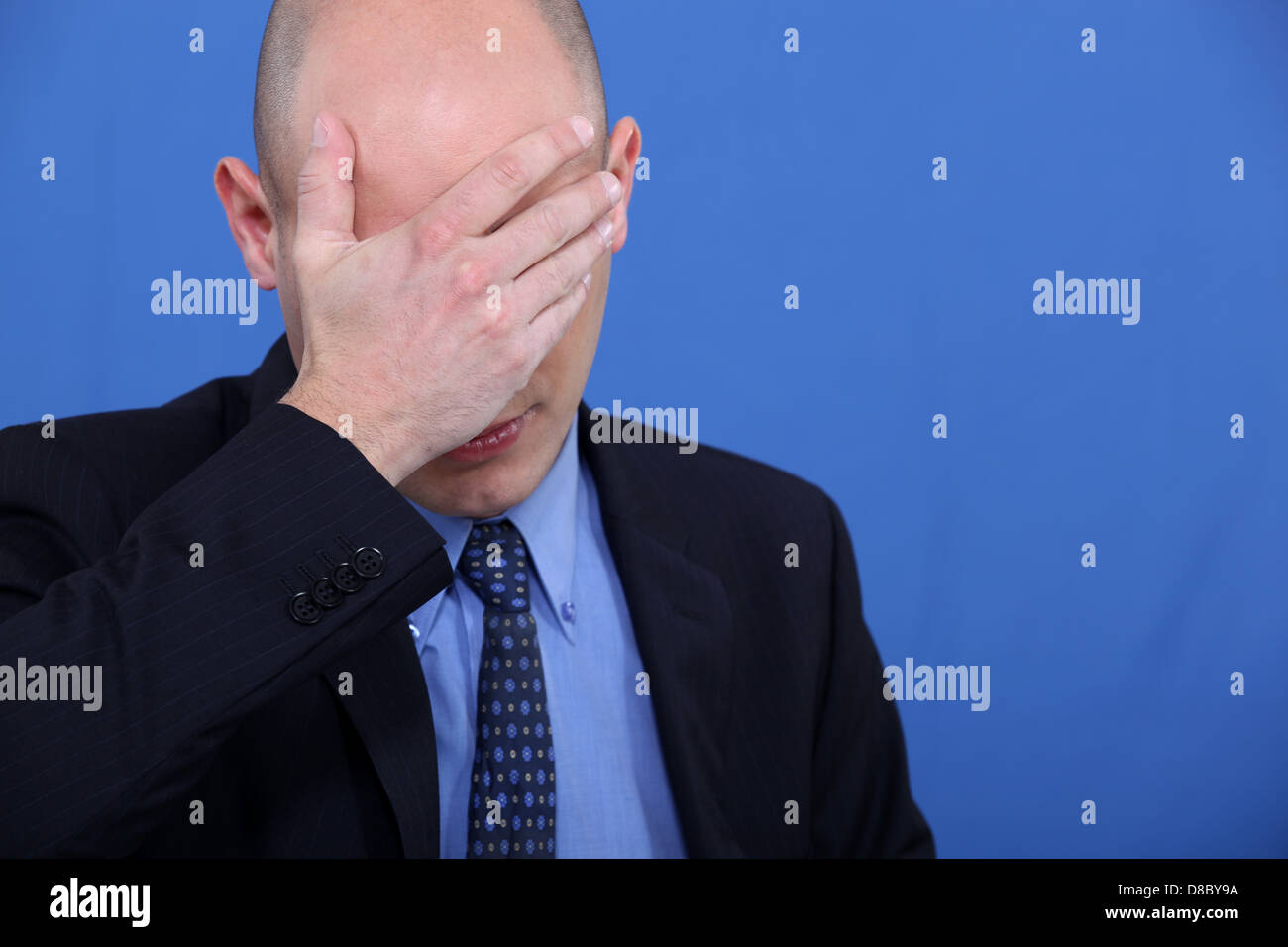 Businessman with a headache Stock Photo - Alamy
