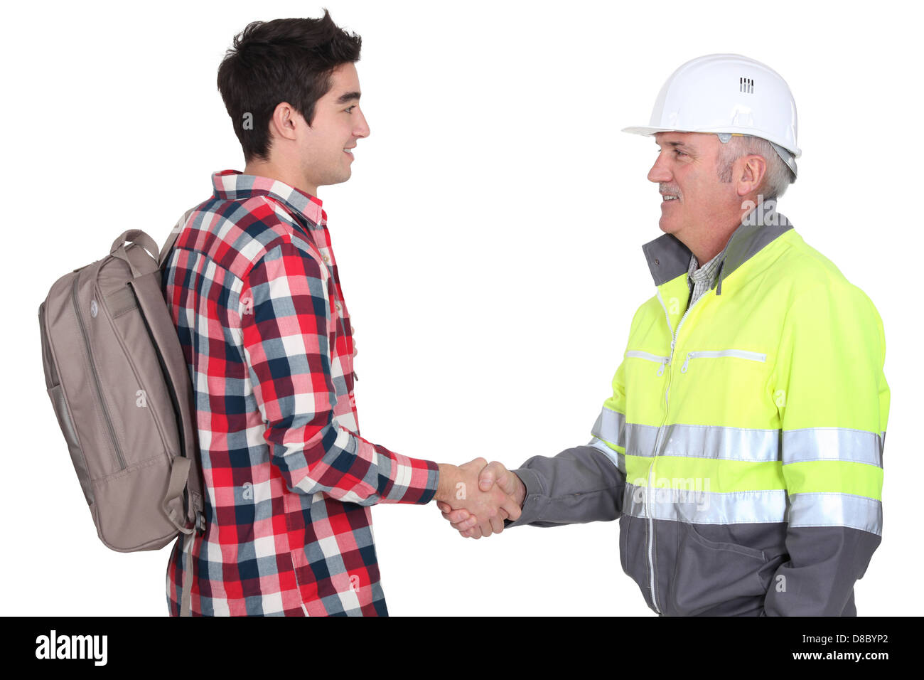 Builder welcoming apprentice Stock Photo - Alamy