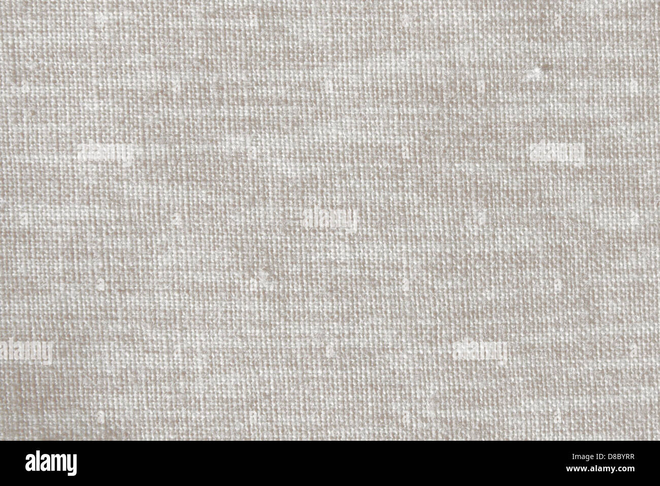 This close-up image shows the intricate texture of white woven fabric ...