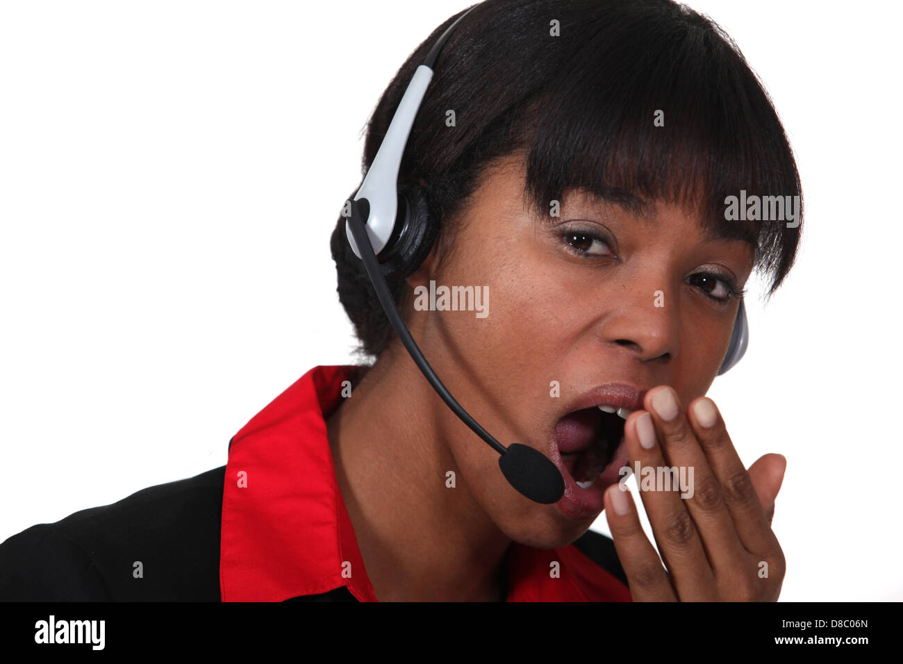 Woman with headset yawning Stock Photo - Alamy