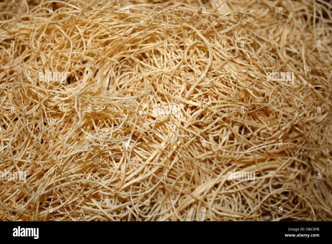 A close-up image of wood excelsior packing material, featuring thin ...