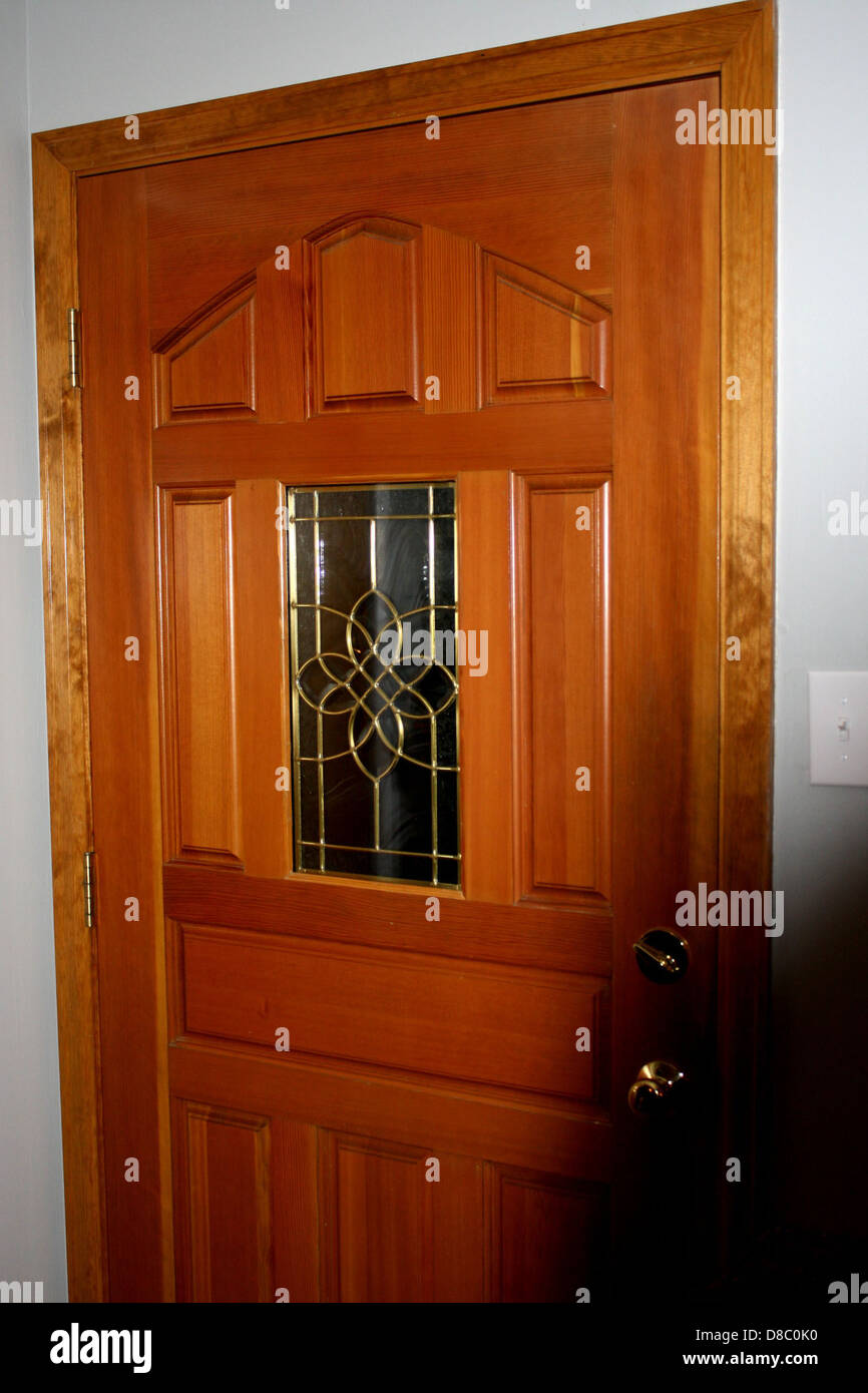 A close-up of a wooden entry door with intricate designs. The door’s ...