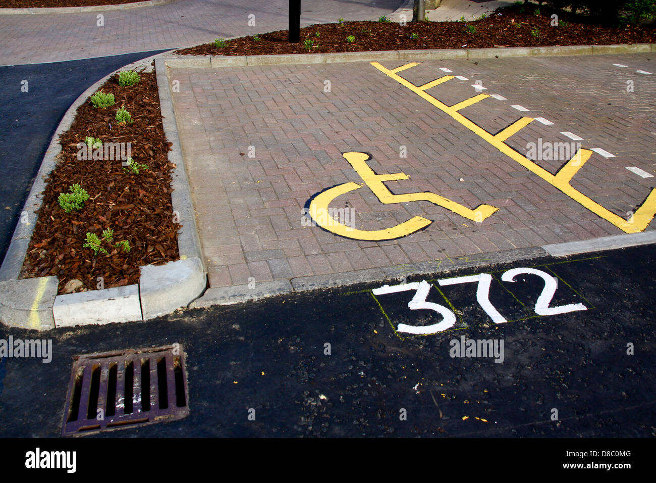 Disabled parking space with yellow hatching and number 372 Stock Photo ...