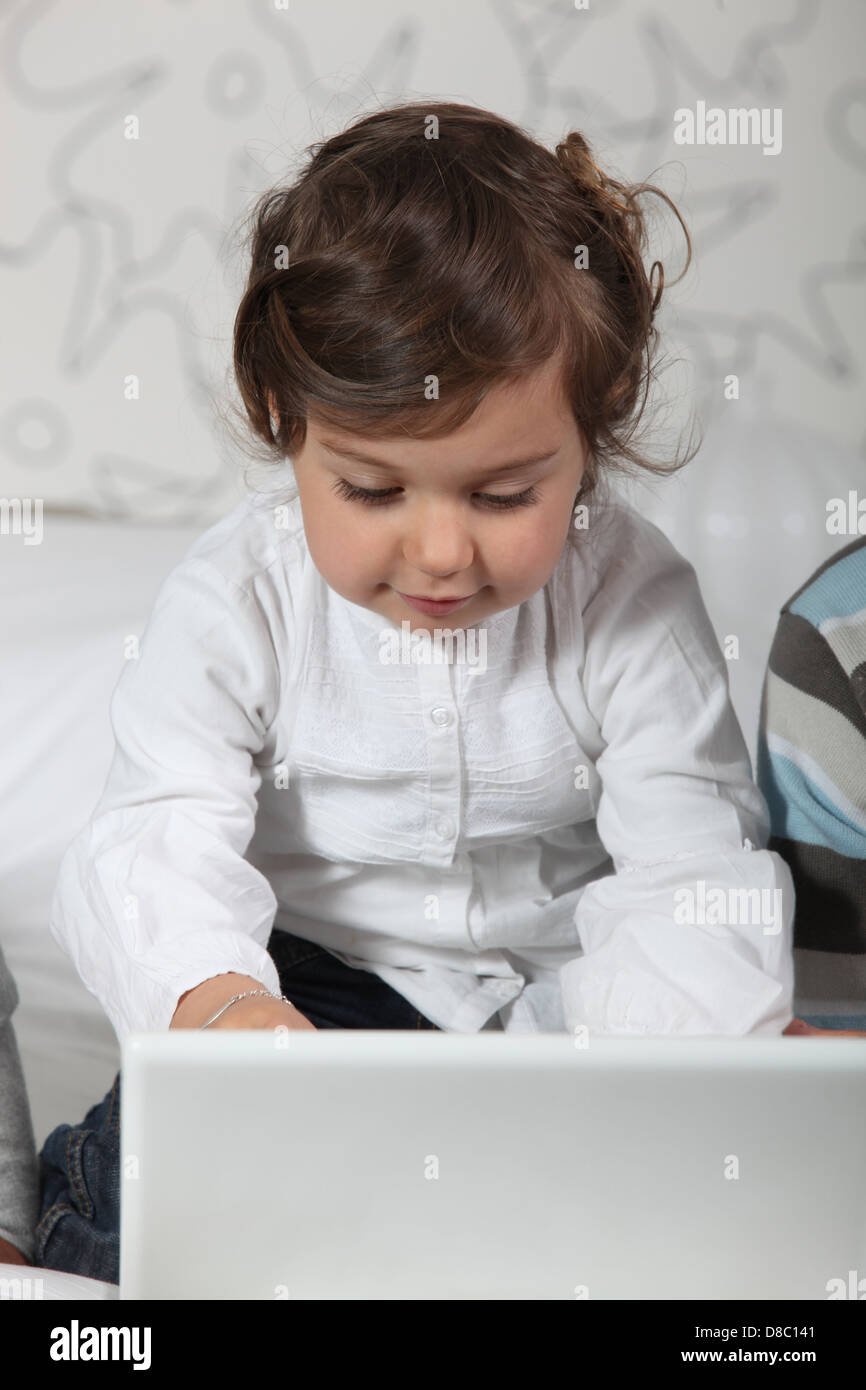 Toddler using laptop Stock Photo - Alamy