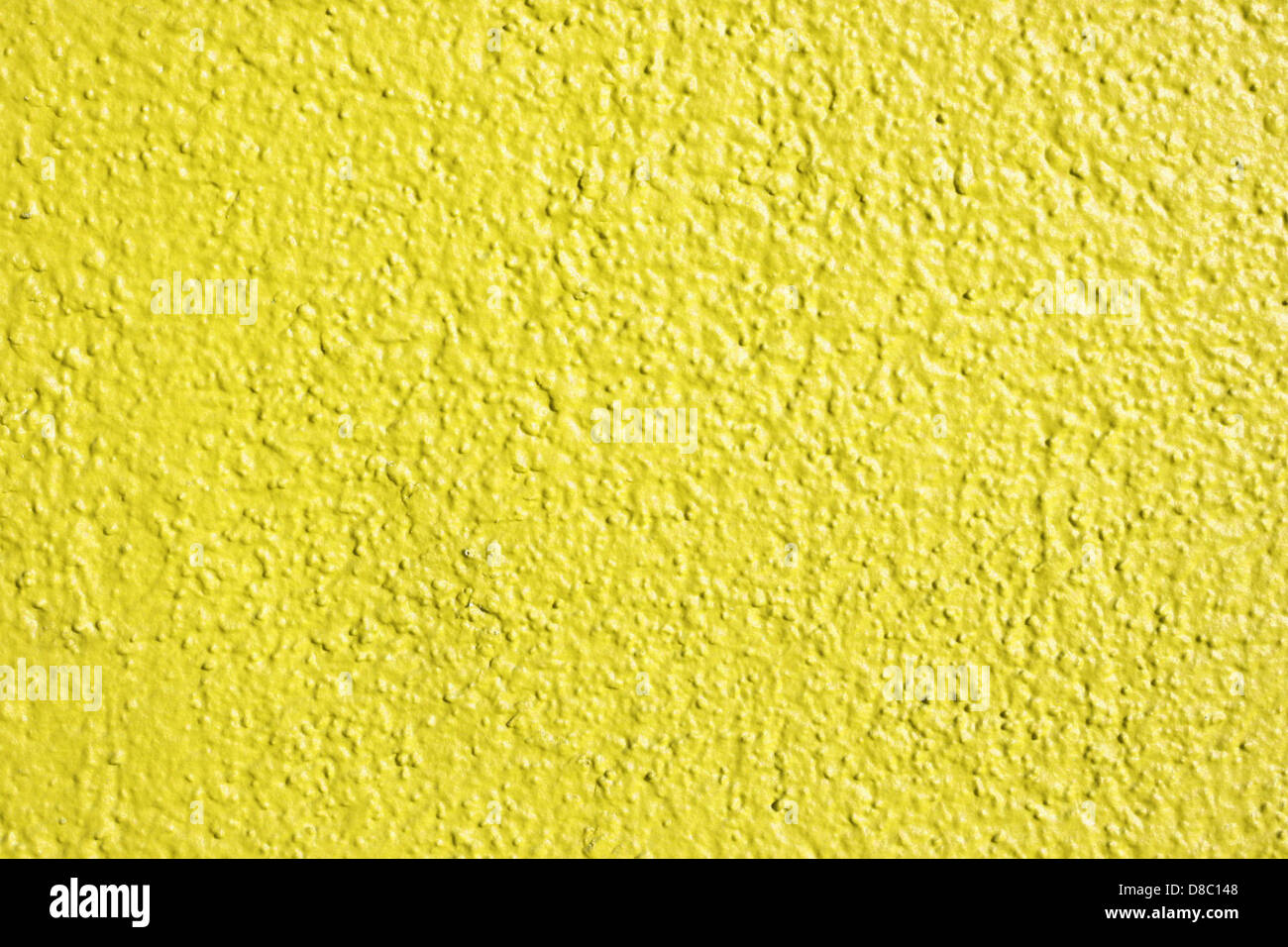 This stock photo captures the texture of a yellow-painted wall. The ...