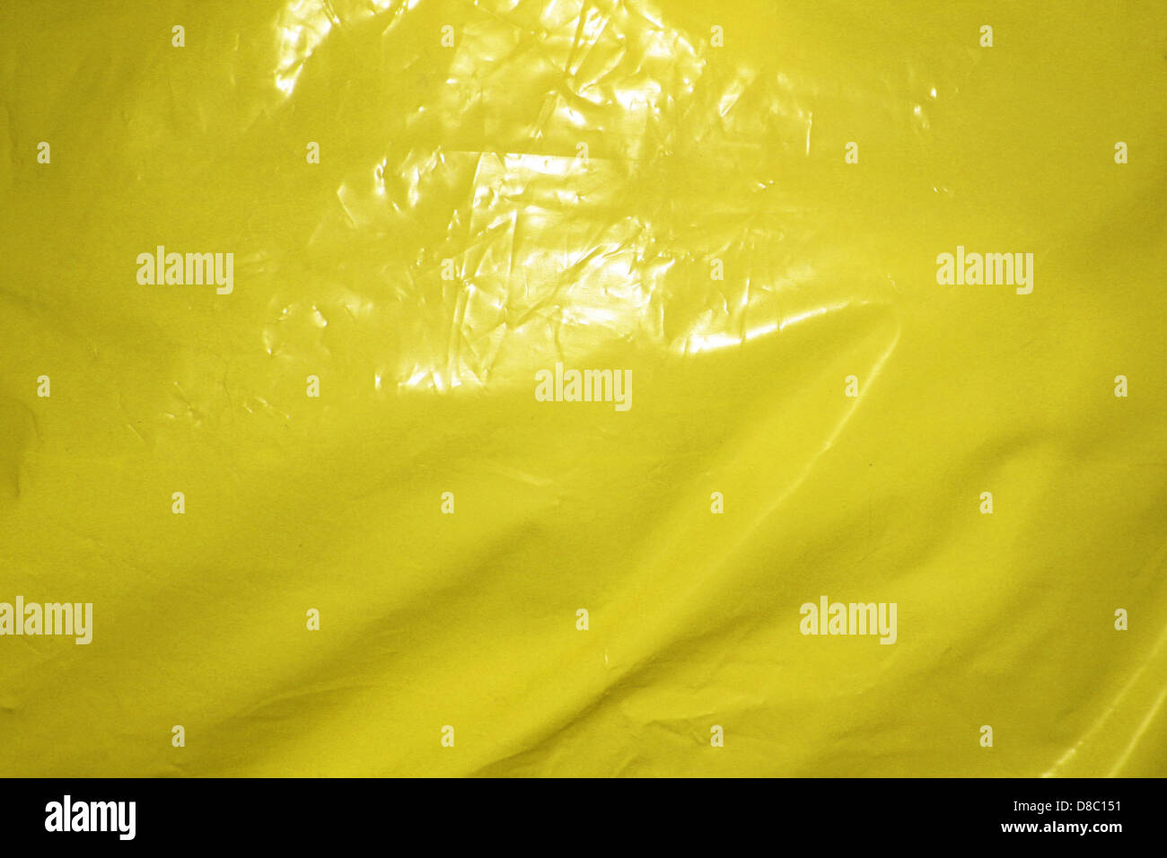 A close-up of yellow plastic with a smooth texture, often used in ...