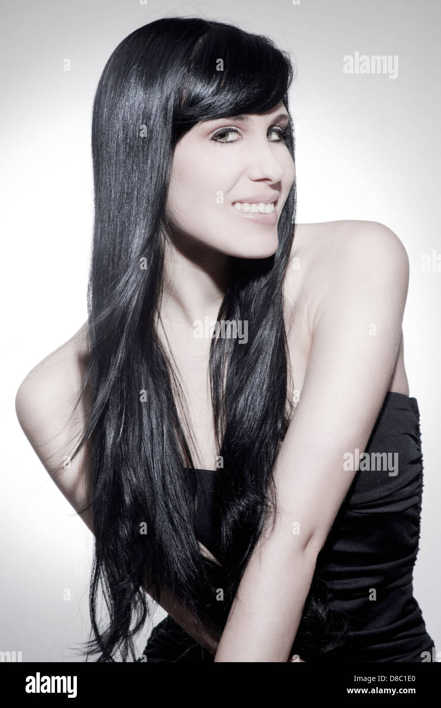 Attractive dark-haired young woman wearing black dress, portrait Stock ...