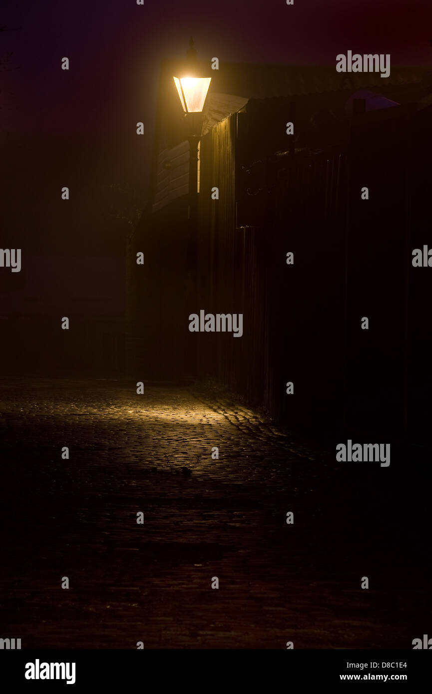 Single street lamp in a dark alley, with cobbled path Stock Photo - Alamy