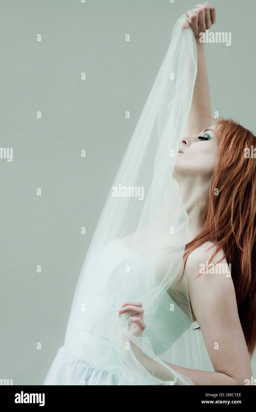 Red-haired young woman wearing dress and transparent cloth Stock Photo - Alamy