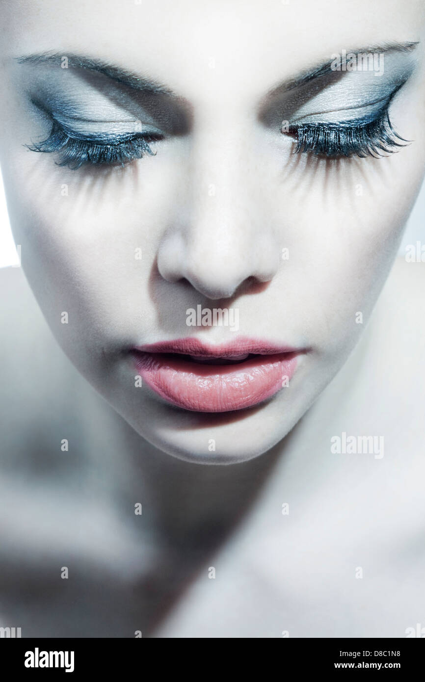 Attractive young woman looking down Stock Photo - Alamy