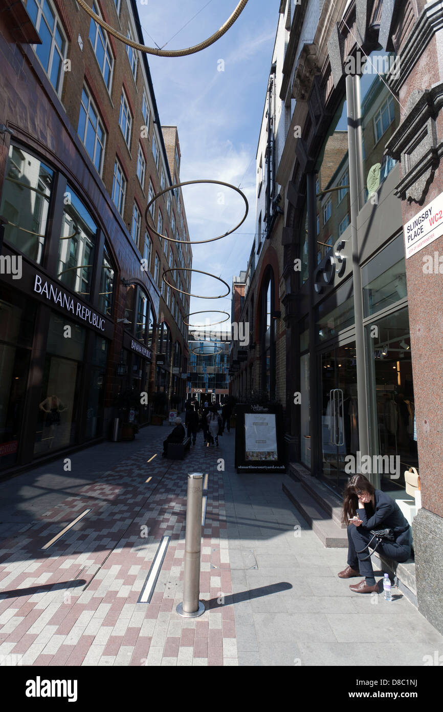 Woman sitting at Slingsby place St Martins Court Yard wc2 London Stock ...
