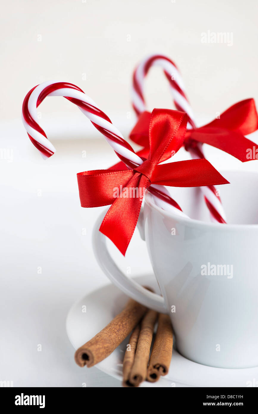 Cup decorated with candy canes, red ribbon and cinnamon sticks Stock ...