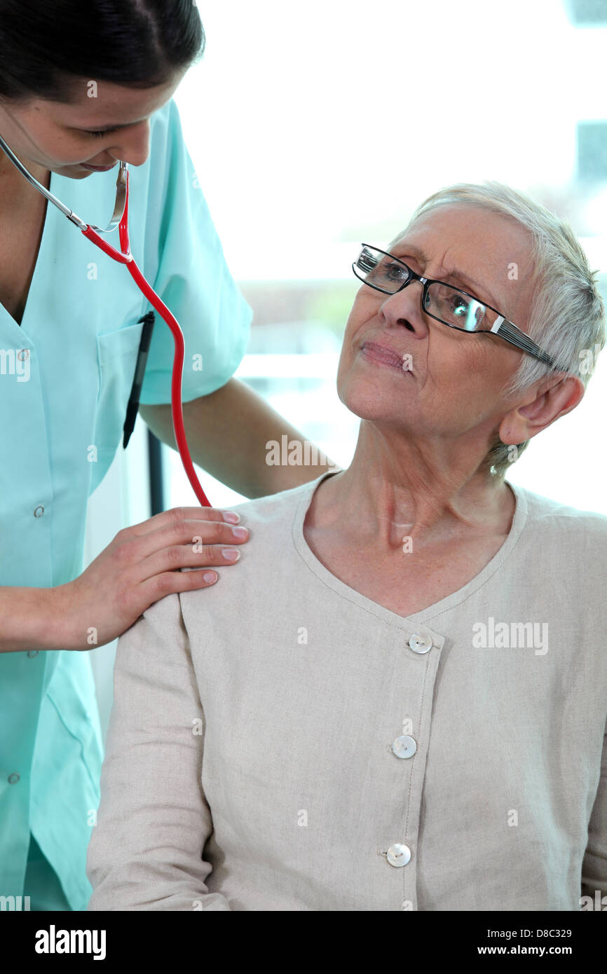 Nurse taking patient's heart rate Stock Photo - Alamy