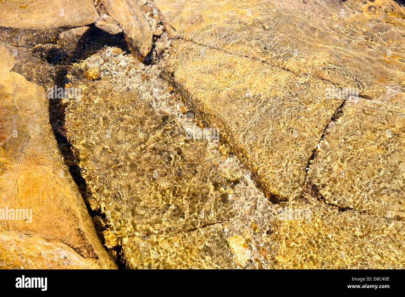 Abstract view of clear rippling stream water flowing over rock and ...