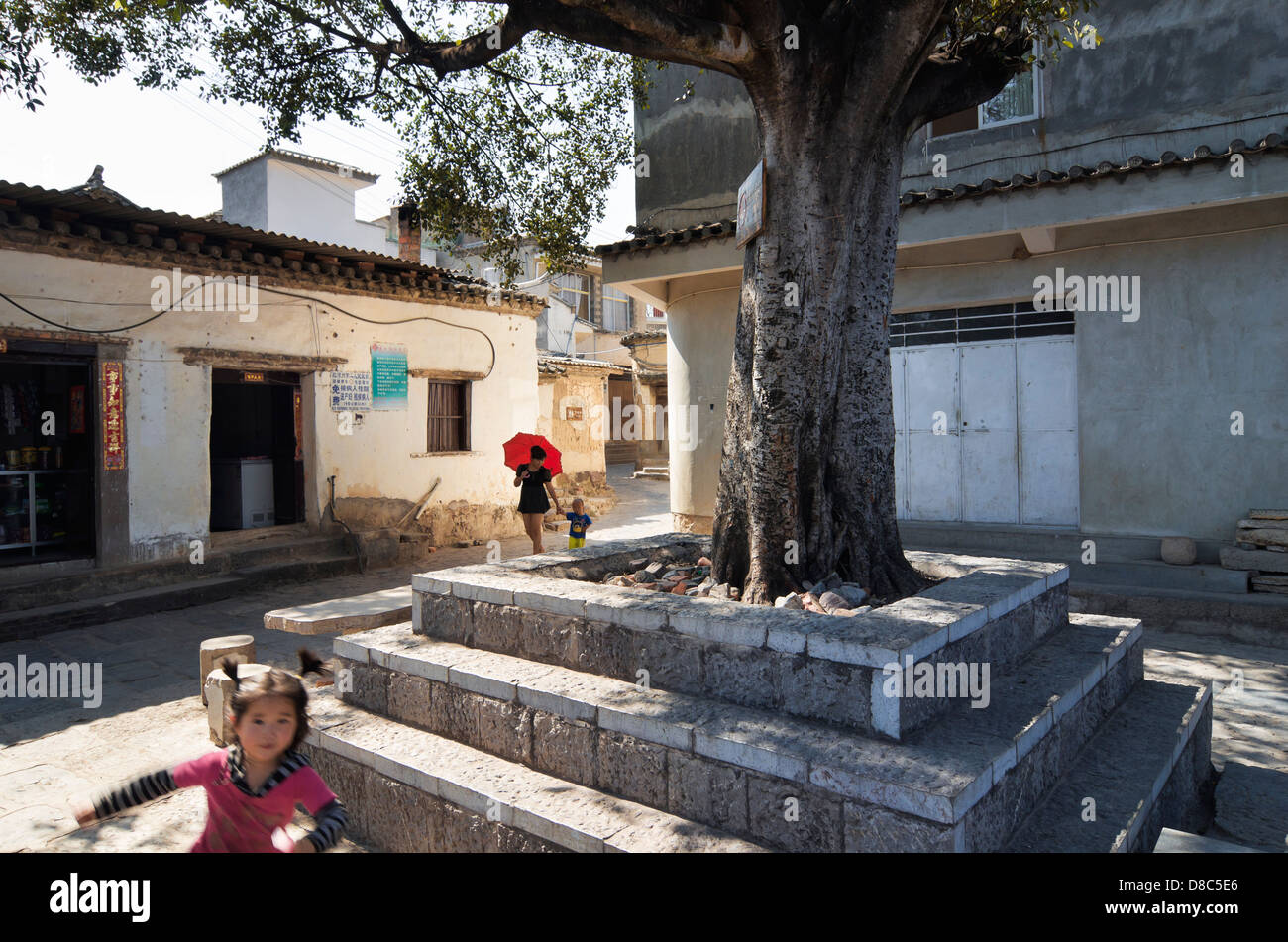 People strolling in a square of the Tuanshan Historical Village in ...