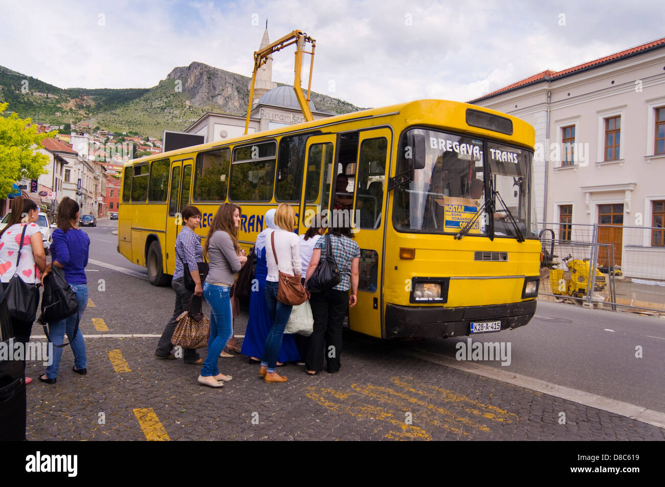 Passengers board a bus in Mostar in Bosnia Herzegovina Stock Photo - Alamy