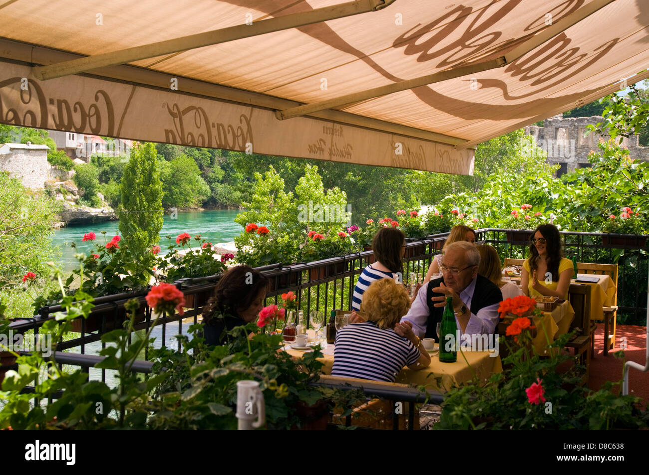 Customers at Hindin Han Restoran Restaurant by river in Mostar in ...