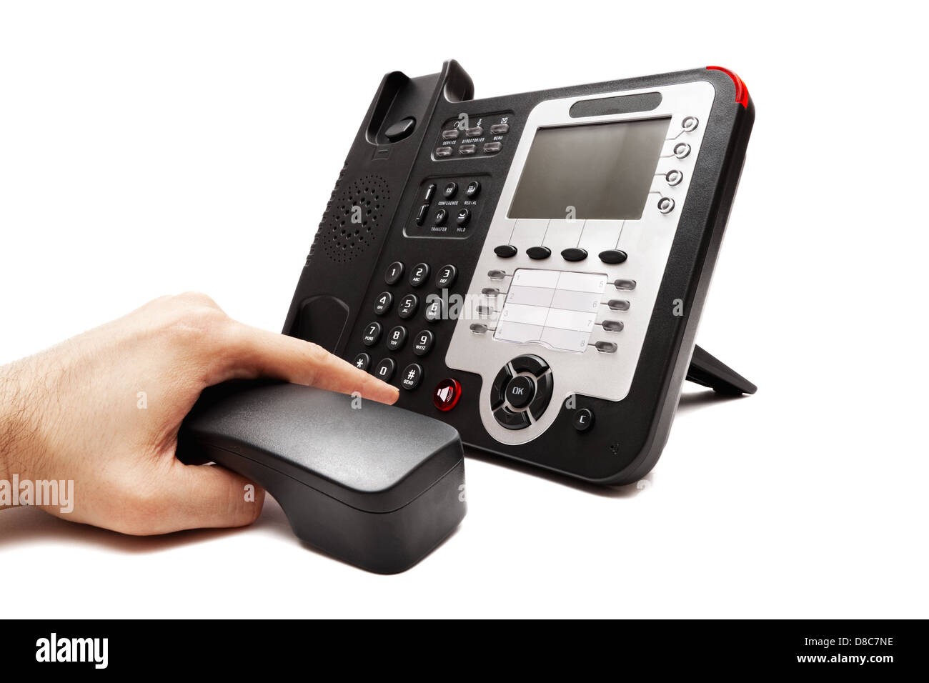 Men's hand dials the number on the black phone isolated on white ...