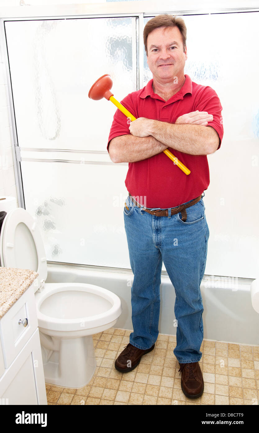 Plumber or homeowner holding a plunger and standing in a modern ...