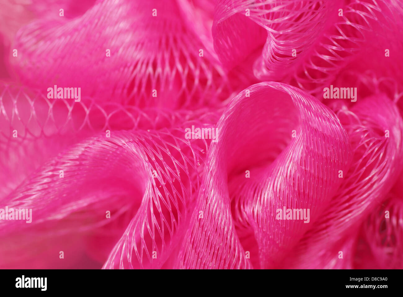 Macro of a pink bath puff or sponge, plastic mesh detail, texture ...