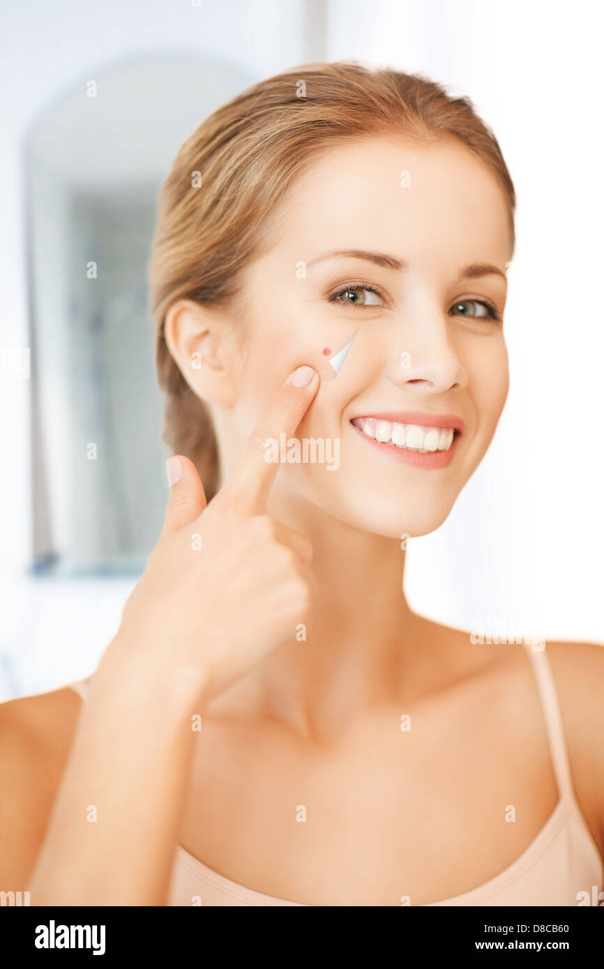 beautiful woman pointing to nose Stock Photo - Alamy