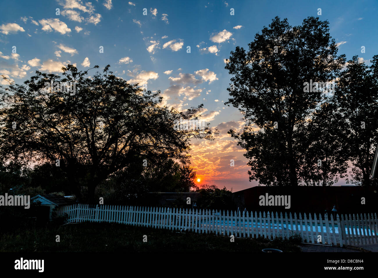 A colorful sunrise over a backyard swimming pool Stock Photo - Alamy