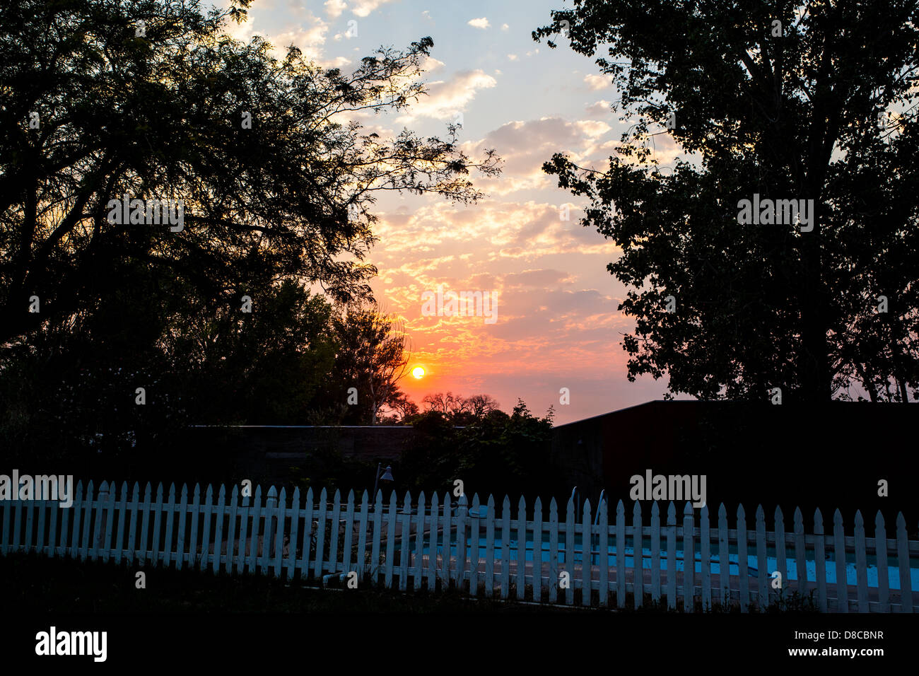 A colorful sunrise over a backyard swimming pool Stock Photo - Alamy